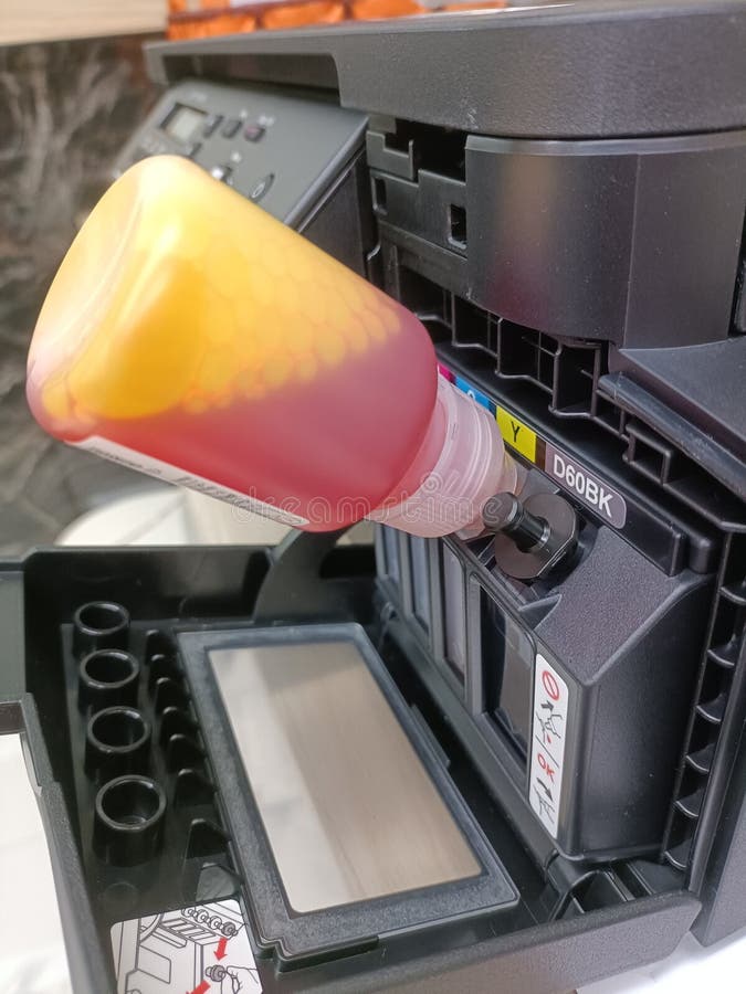 Photo Close-up. Refilling Yellow Ink into a Multifunction Printer Stock ...