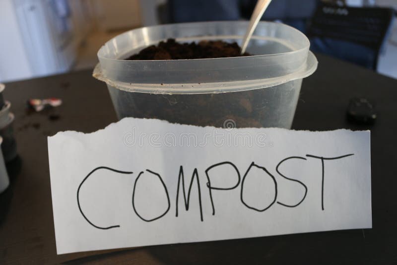Photo of a Container of Used Coffee Grounds with a Sign that Says ...