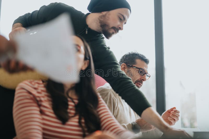 Photo of a Cross Generational Creative Team Intensely Discussing ...