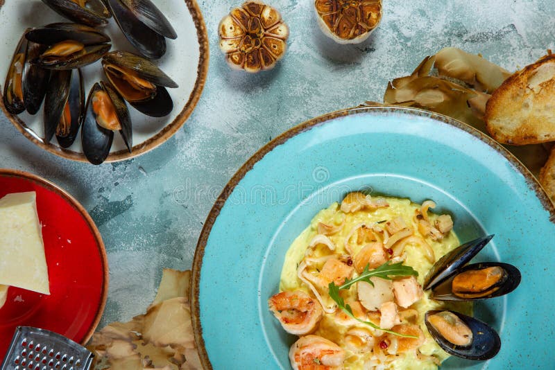 Photo of Delicious Risotto with Saffron and Seafood on Table. Stock ...