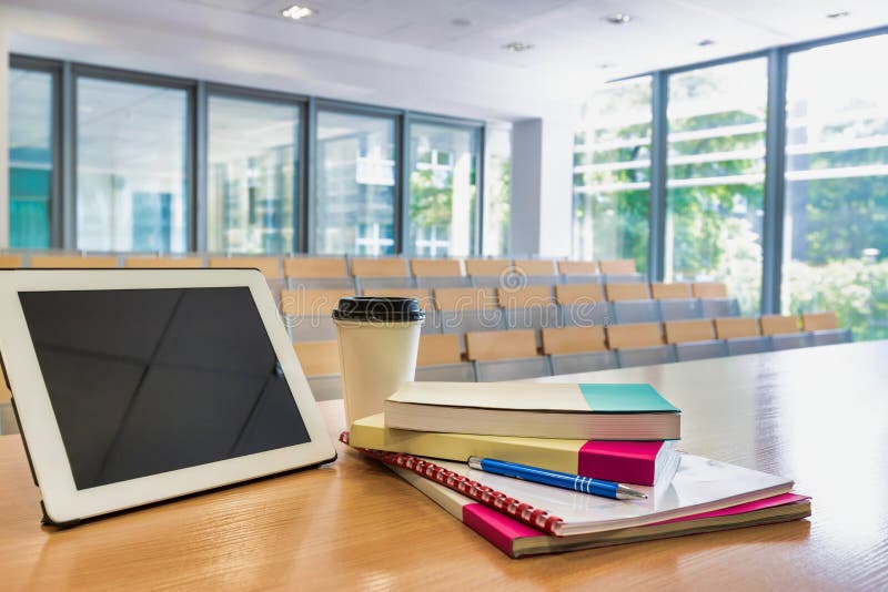 Photo of Digital Tablet, Books and Cup of Coffee on Table in Classroom ...