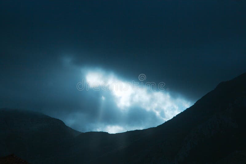 Dramatic Sun Rays Beaming Down on Mountains Stock Image - Image of ...