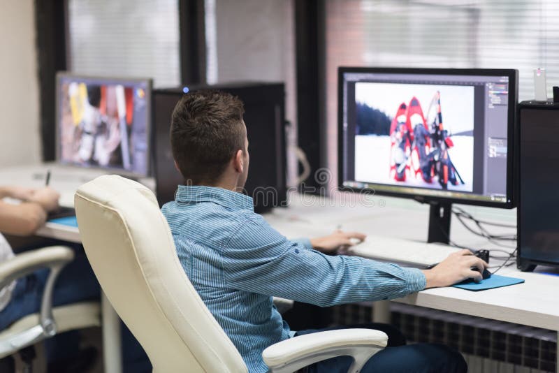 Photo editor at his desk stock photo. Image of computer - 67629872