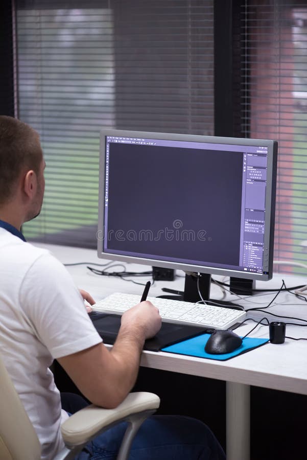 Photo editor at his desk stock photo. Image of computer - 67629872