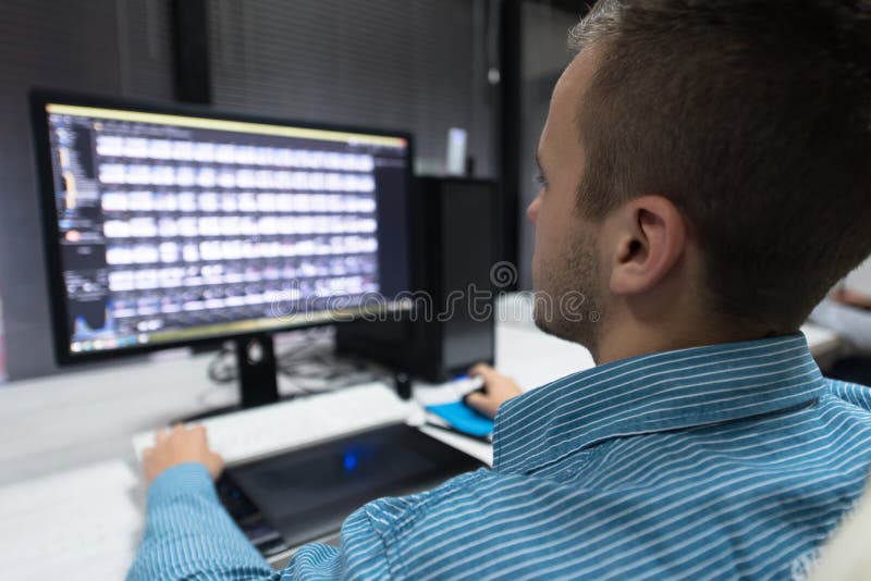 Photo editor at his desk stock photo. Image of company - 67636762