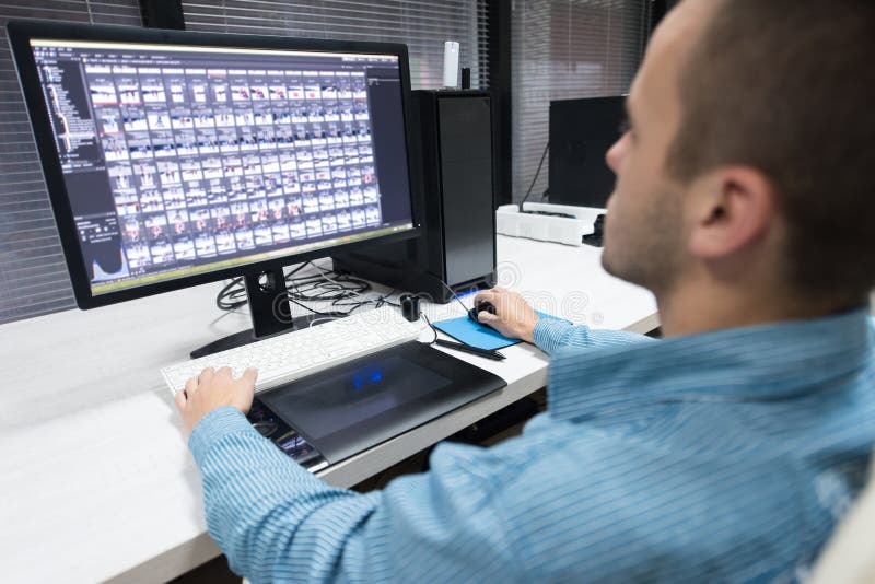 Photo editor at his desk stock image. Image of professional - 67637903