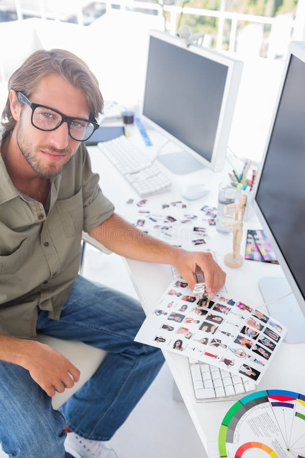 Photo Editor Looking Up from His Work Stock Image - Image of female ...