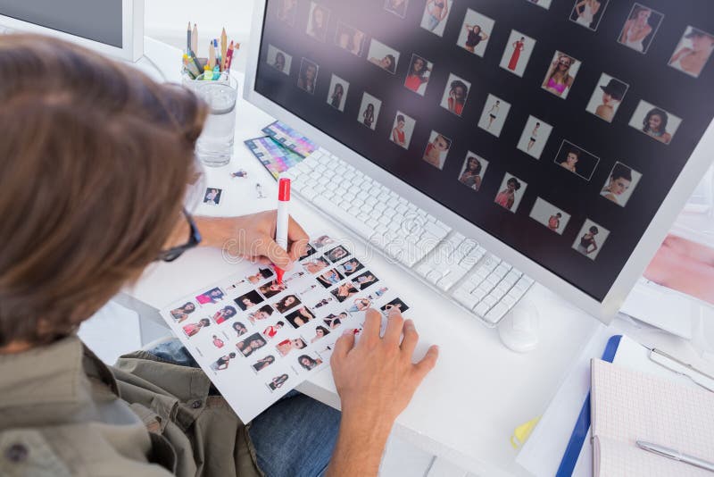 Editor Marking the Contact Sheet and Looking at Camera Stock Image ...