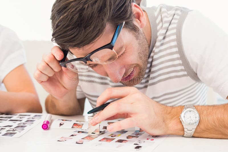 Photo Editor Using a Magnifying Loupe Stock Image - Image of facial ...