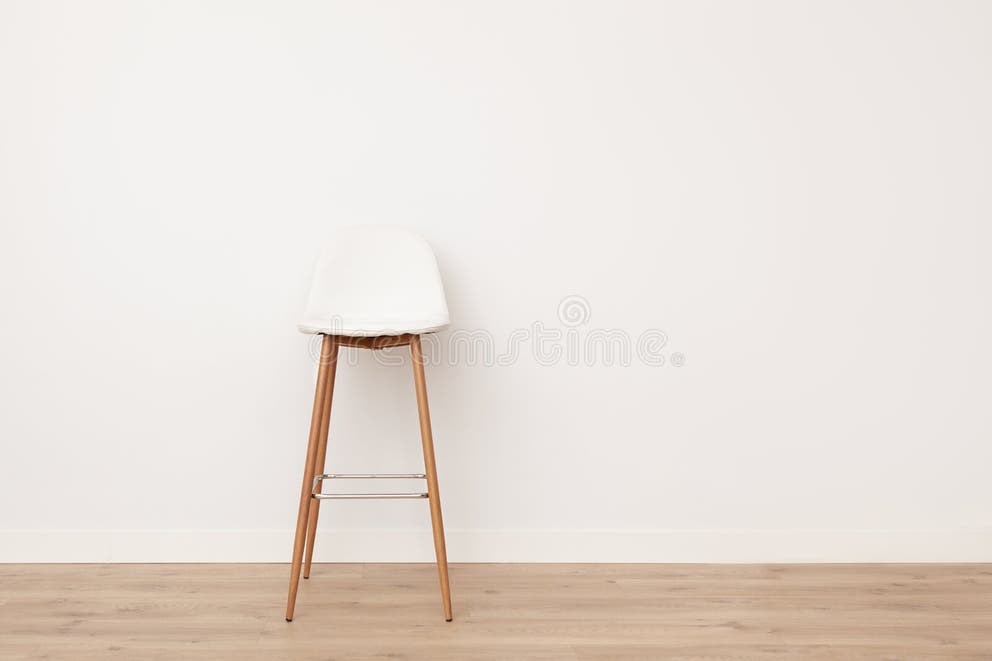 Photo of an Empty Bar Stool Standing in Front of a White Wall Stock ...