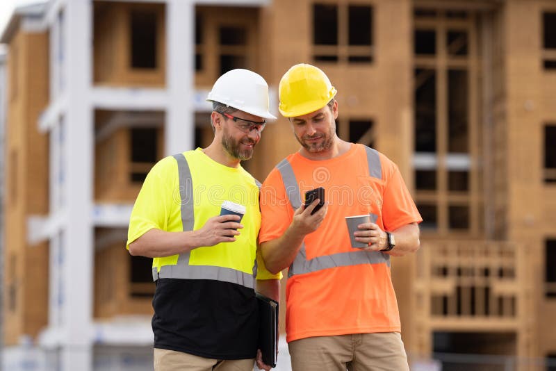 Photo of Engineer Men Using Phone at Construction Site. Engineer Men at ...