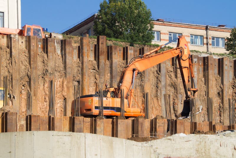 On the Photo Excavator Performs Excavation Work on the Swamp Stock ...