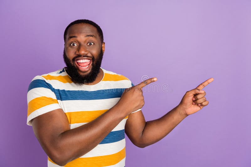 Photo Of Excited Cheerful Man Wear Striped T Shirt Pointing Two Fingers