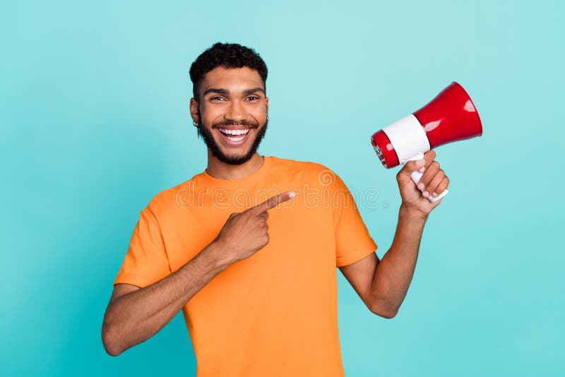 Photo Of Excited Cool Guy Wear Orange T Shirt Pointing Finger Bullhorn