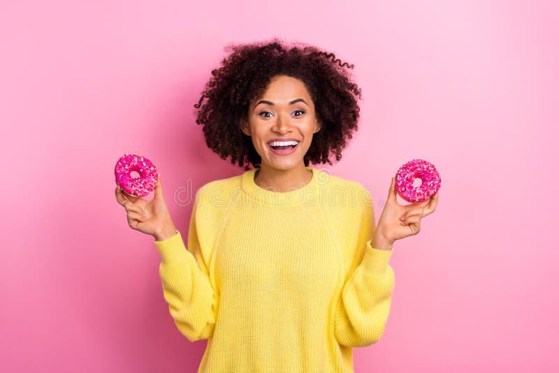 Photo Of Excited Sweet Woman Dressed Kitted Pullover Holding Two Donuts