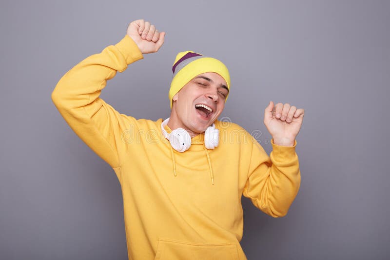 Photo of Extremely Happy Overjoyed Hipster Man Wearing Yellow Hoodie ... Photo of Extremely Happy Overjoyed Hipster Man Wearing Yellow Hoodie ...