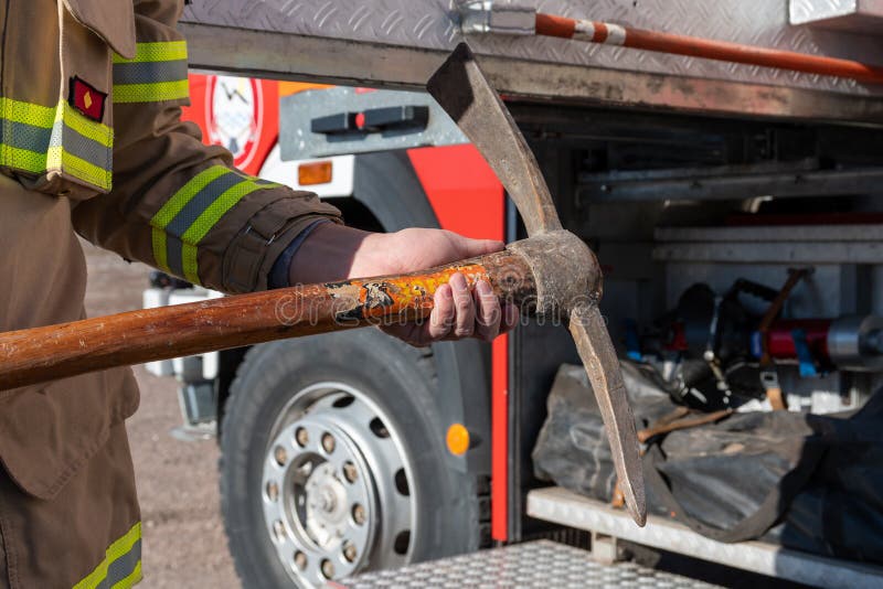 Photo of Fireman with Hammer Against Fire Machine Stock Image - Image ...
