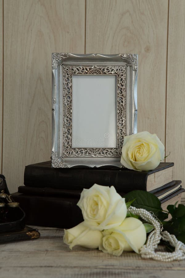Photo Frame, Book and Flowers on Table Stock Image - Image of floral ...