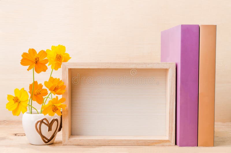 Photo Frame with Books and Flowers on the Wooden Table Stock Photo ...