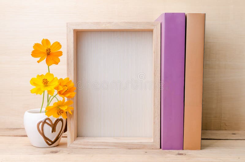 Photo Frame, Books and Flowers on the Wooden Table with Blue Woo Stock ...
