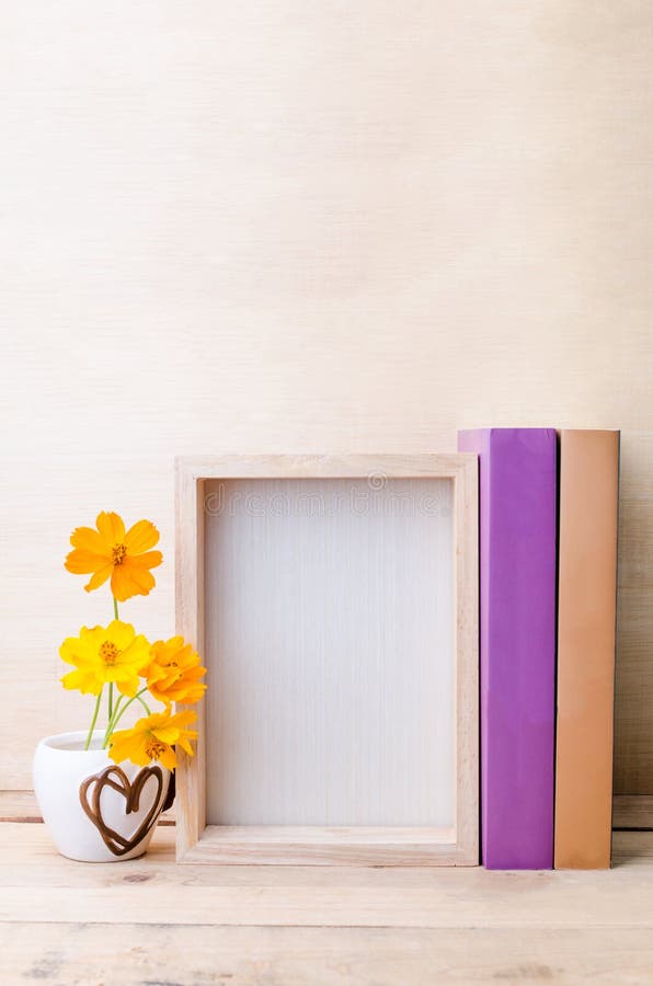 Photo Frame with Books and Flowers on the Wooden Table Stock Photo ...