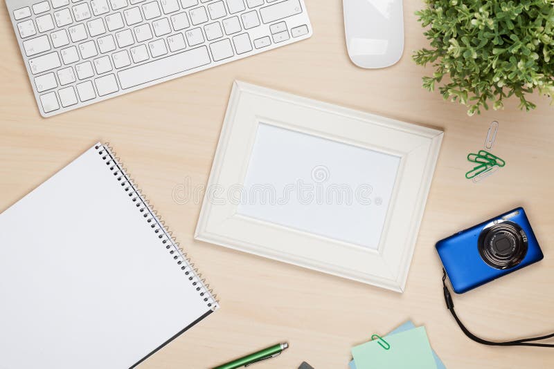 Photo Frame on Office Table with Notepad, Computer and Camera Stock ...