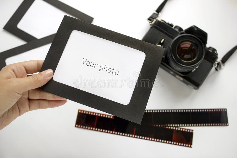 Hand with Photo Frame on Camera Background and Film Stock Image - Image ...