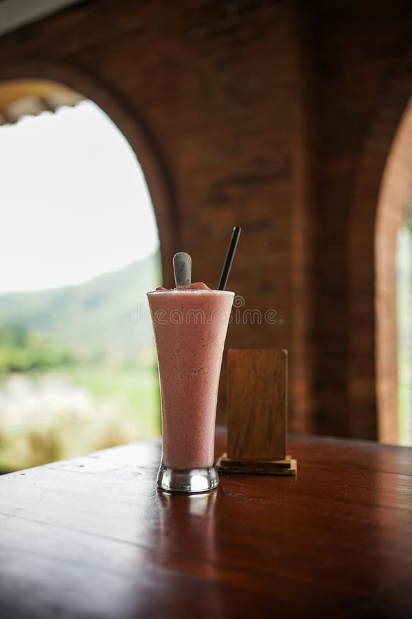 A Glass of Strawberry Smoothie on the Restaurant Table Stock Image ...