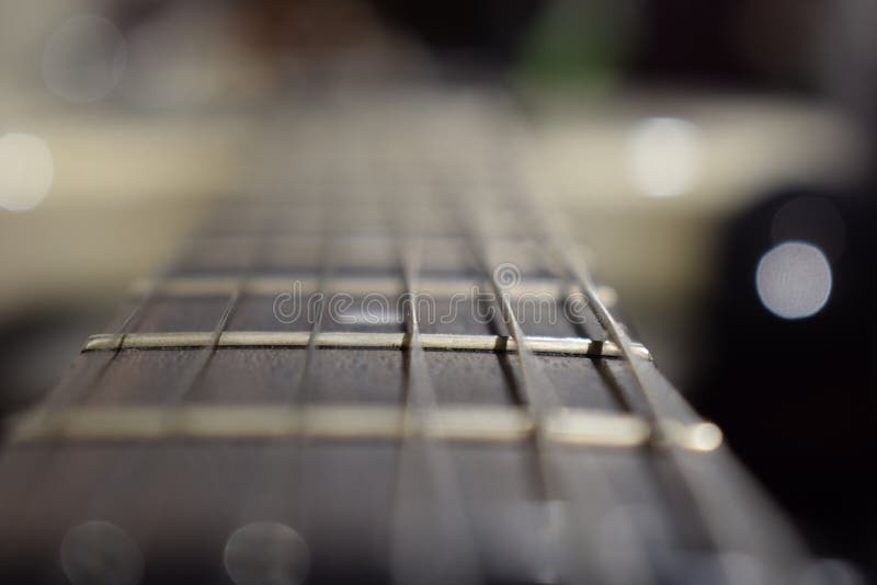 A Photo of a Guitar Neck with Strings and a Wood Texture - the Material ...