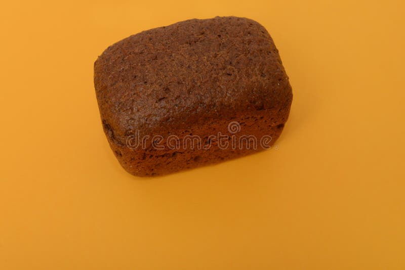 Photo of Handmade Black Bread on Orange Background Stock Photo - Image ...