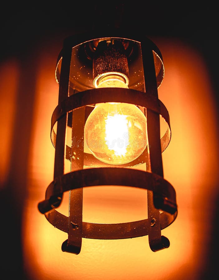 Photo of an Incandescent Lamp Light on in Rustic Support. Stock Image ...