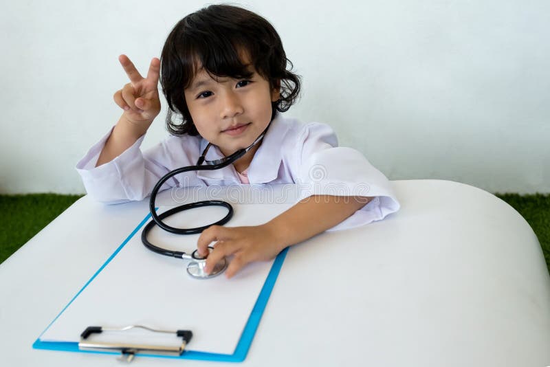 Photo of Kid Doctor with Stethoscope Working in the Office Stock Photo ...