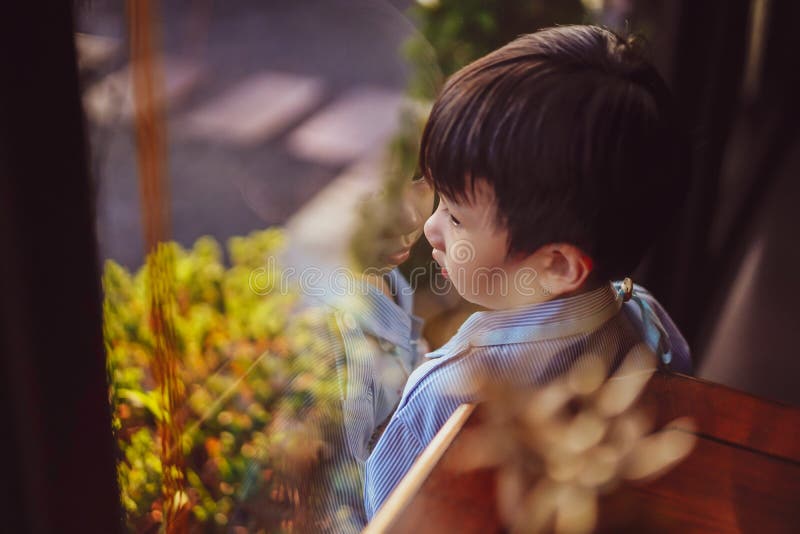 Photo of Little Boy Looking Out the Window. Stock Photo - Image of ...