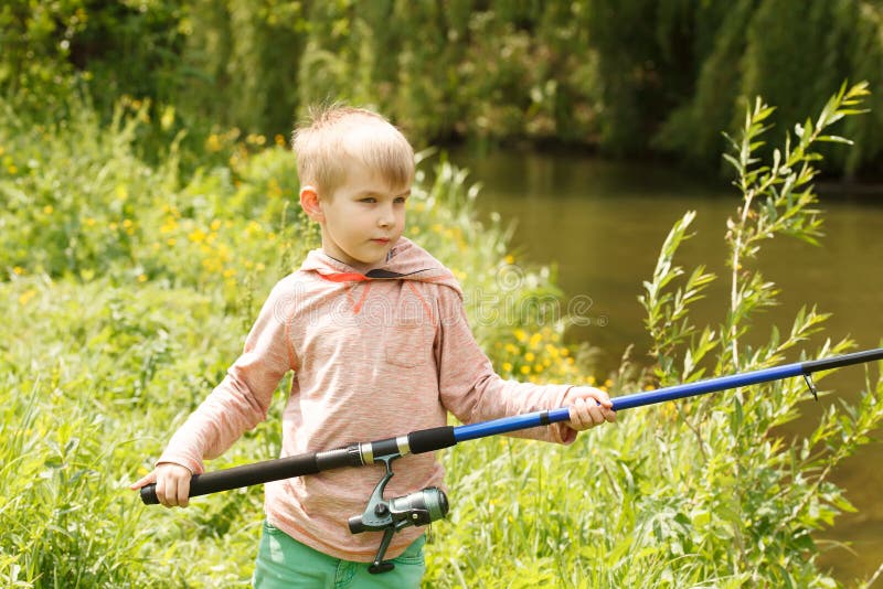 Photo of Little Kid Pulling Rod while Fishing on Weekend Stock Photo ...