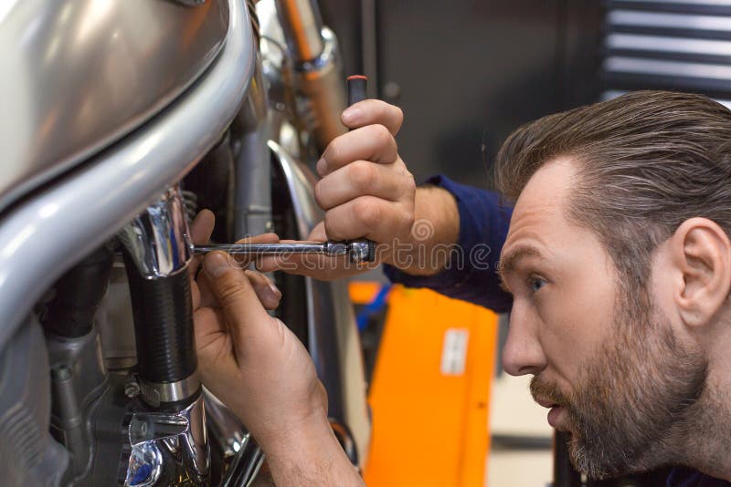 Photo of a Man Fixing Something in a Mechanical Workshop Stock Photo ...