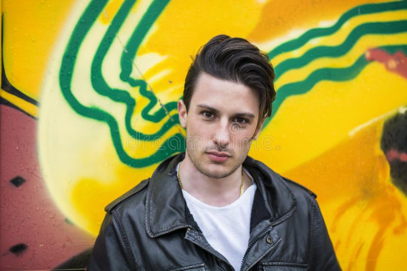 Photo of a Man Posing in Front of a Vibrant and Eye-catching Wall Stock ...