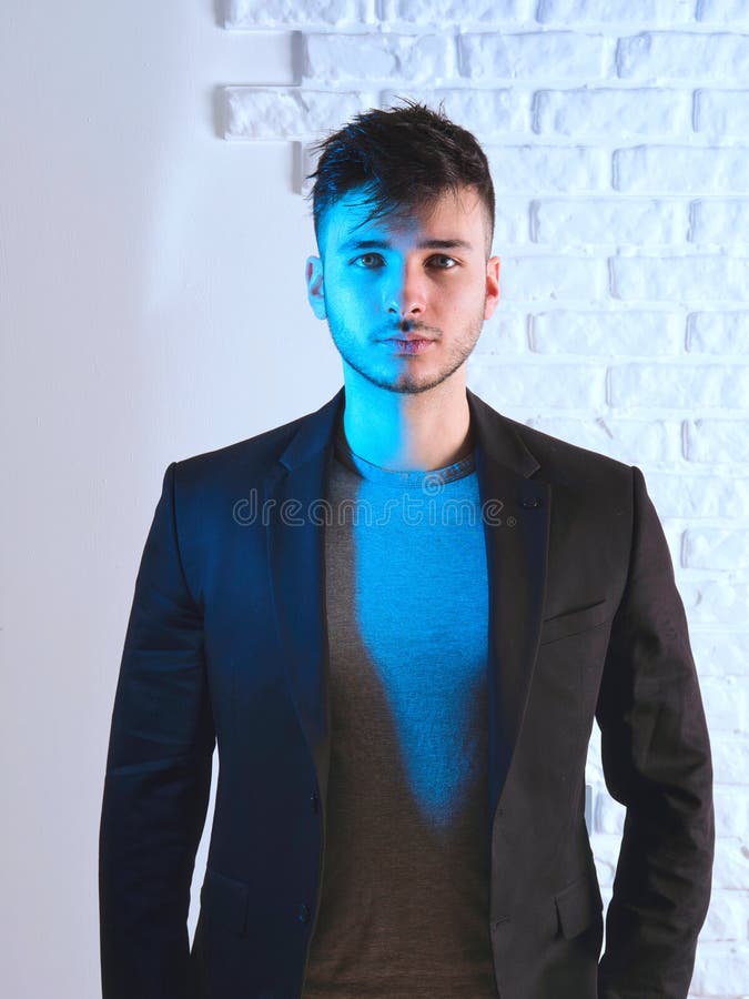 Photo of a Man Standing in Front of a White Brick Wall Stock Photo ...