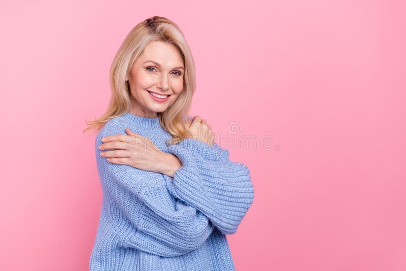 Photo Of Matture Funny Blond Lady Hug Herself Wear Blue Sweater