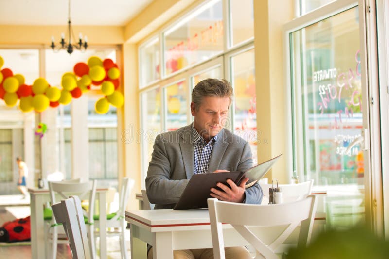 Boy Reading Menu at Restaurant Stock Image - Image of coffee, customer ...