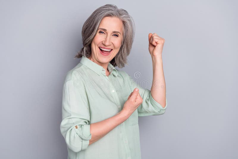 Photo Of Mature Smiling Good Mood Excited Woman Raise Fists In Victory