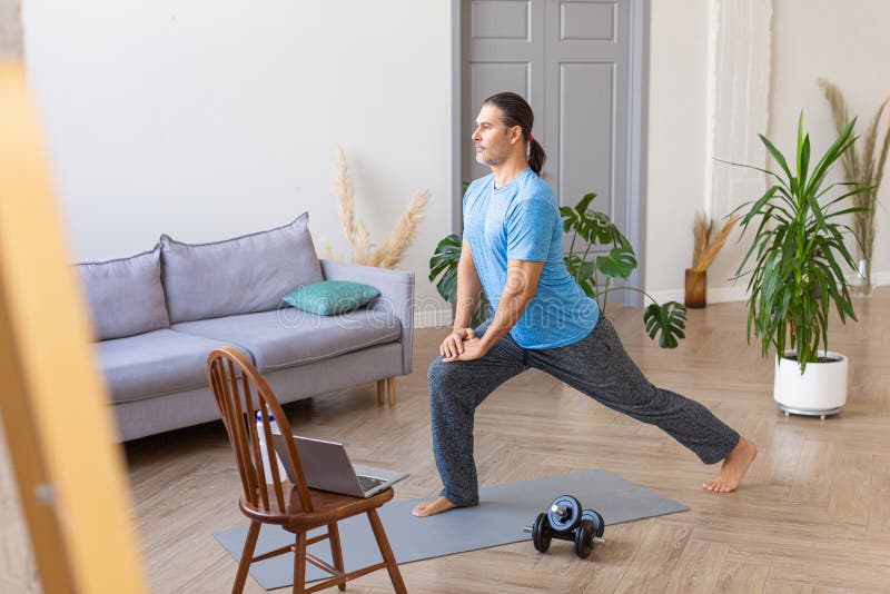 Photo of a Middle Aged Man during Online Home Workout- he Using a ...