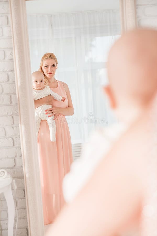 Mom Looks with Her Son in the Mirror Stock Photo - Image of bright ...