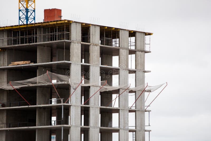 A Multi-storey Building Under Construction Against a Gray Sky Stock ...