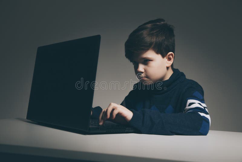 Photo of Nice Boy in Sweater Sitting Infront of the Computer Doing ...