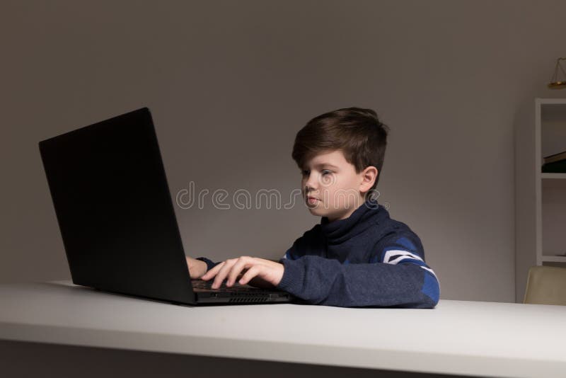 Photo of Nice Boy in Sweater Sitting Infront of the Computer Doing ...