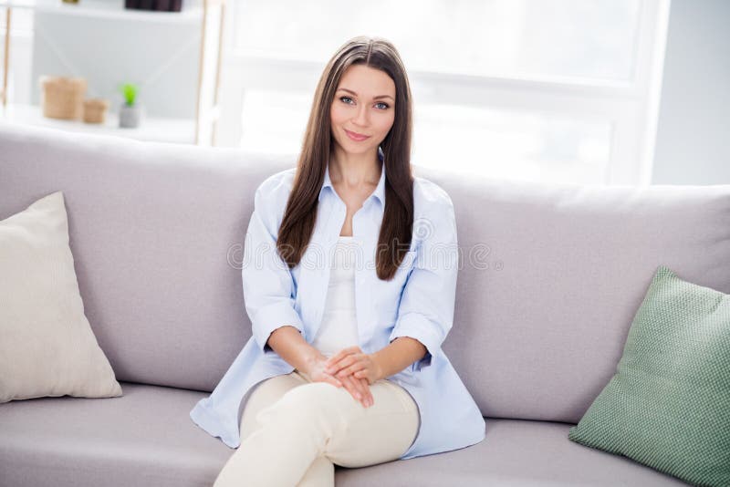 Photo Of Nice Optimistic Brunette Long Hairdo Lady Sit On Coach Wear