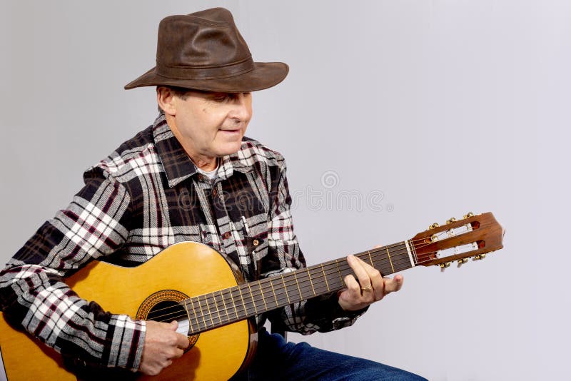 Old Man with Light Eyes Playing Guitar with Gaucho Hat Stock Photo ...
