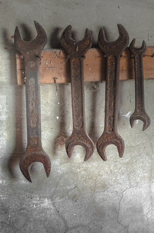 Photo of Old Rusty Tools that are Hanging in the Garage on the Wall ...