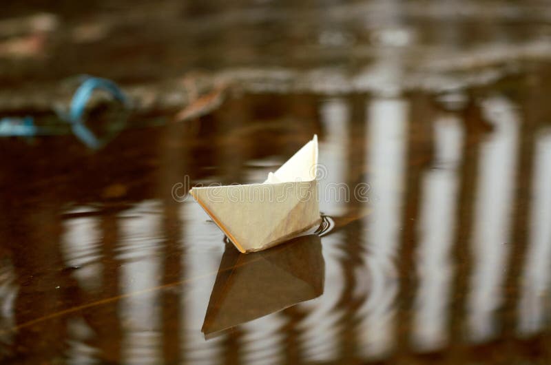Photo of Paper Boat in a Puddle Stock Image - Image of spring ...
