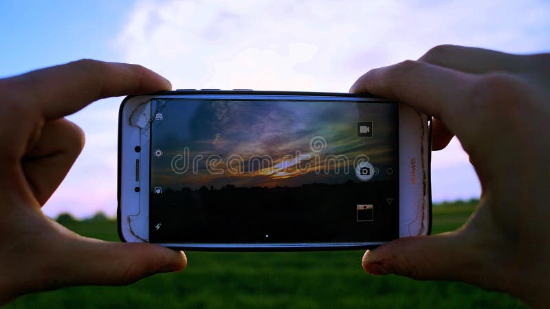 A Photo of a Phone that Shows the Sunset. Stock Image - Image of ...